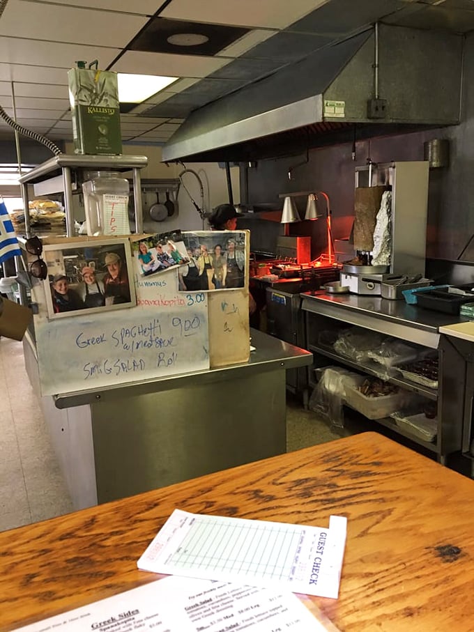 The kitchen view reveals the backstage of flavor production. Those handwritten specials aren't just menu items&mdash;they're today's edible headlines.