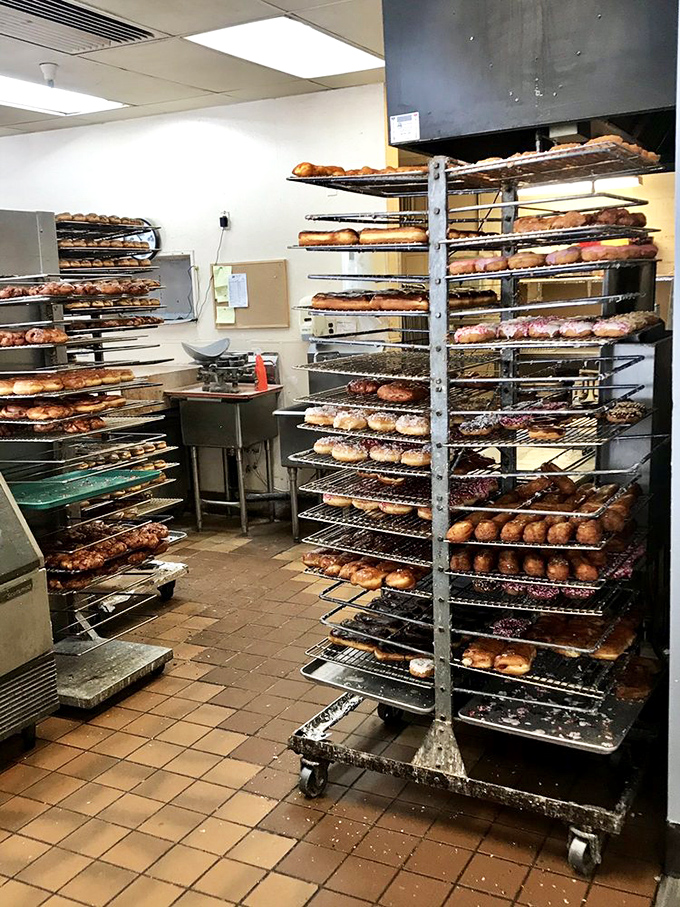 Donut heaven's production line, where rack after glorious rack of freshly made treasures cool before meeting their delicious destiny.