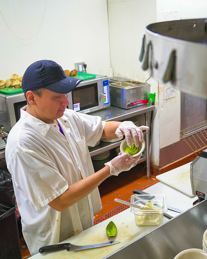 Behind every great omelet is a dedicated chef, carefully preparing each ingredient. The magic happens one avocado at a time.