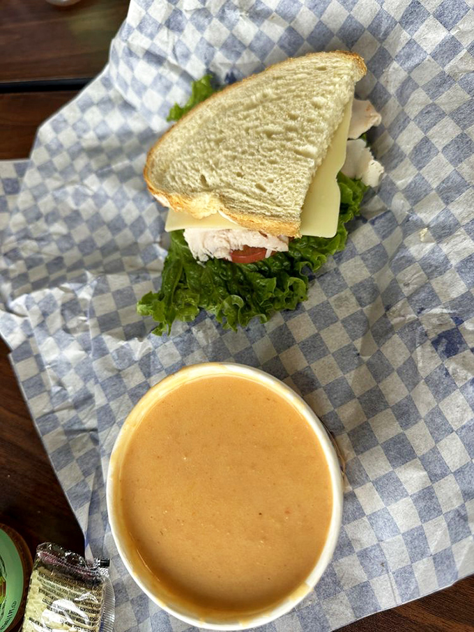 Lunch perfection: A hearty sandwich with fresh greens alongside creamy lobster bisque. Some days you just need both, and that's perfectly okay.