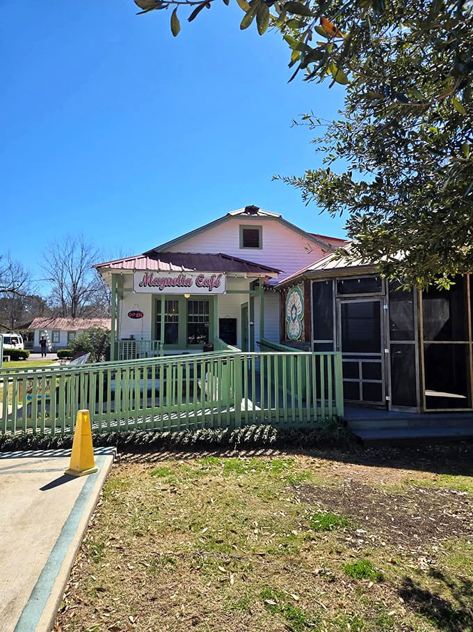 Magnolia Caf&eacute;'s cheerful exterior promises comfort food that hugs your insides. That green porch railing isn't just decorative&mdash;it's the gateway to biscuit nirvana.