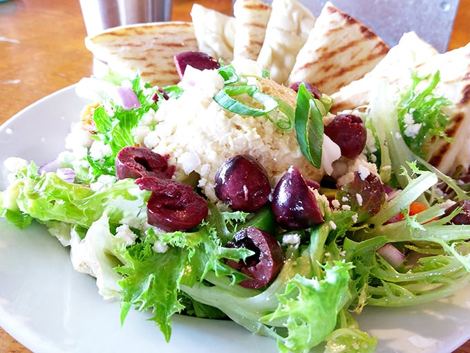 A Mediterranean salad that looks like it just got back from vacation &ndash; tanned olives, relaxed greens, and cheese that's living its best life.