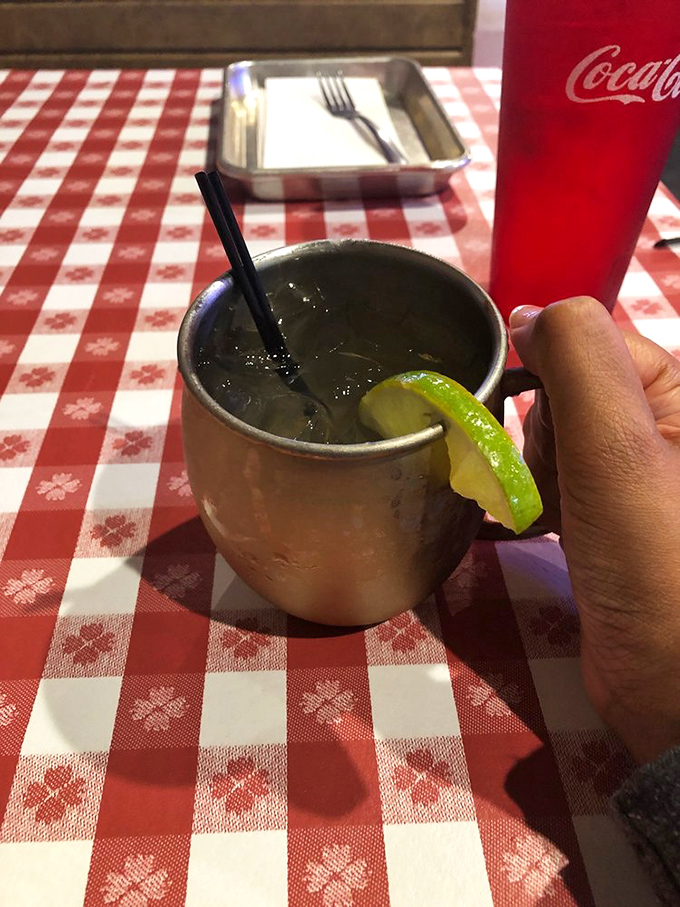 A proper Moscow Mule with lime, served in that signature copper mug. Because sometimes washing down world-class barbecue requires more than just sweet tea.
