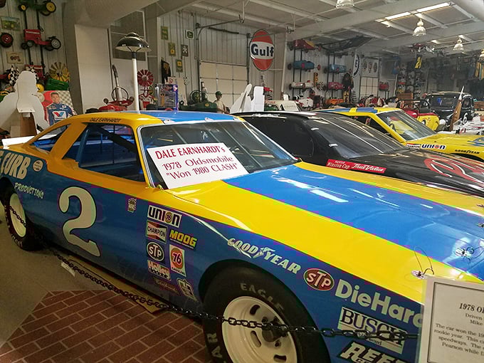 Dale Earnhardt's 1978 Oldsmobile Cutlass gleams under the lights, a yellow and blue time capsule from when the Intimidator was still earning his nickname.