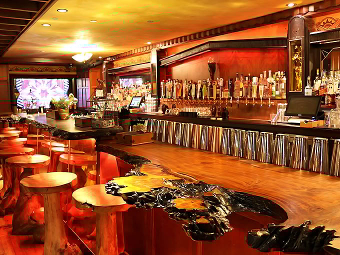 The Monarch Bar's gleaming wood surface looks like it was carved from an enchanted forest, with bar stools that practically whisper "stay for one more."