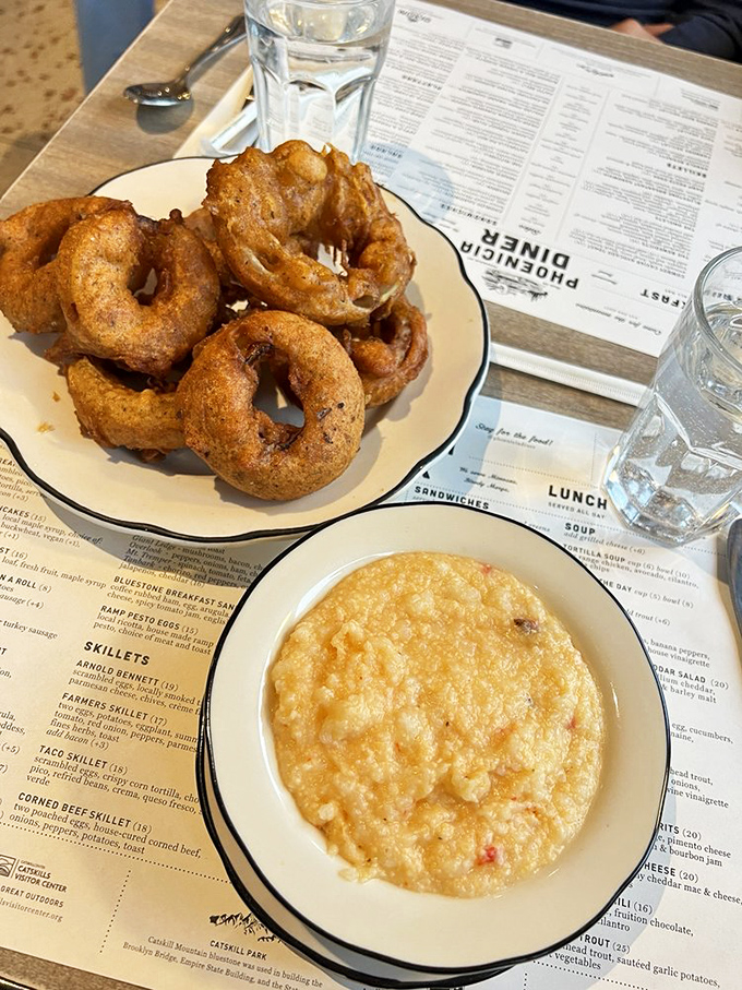 Onion rings with the perfect crunch-to-tenderness ratio alongside creamy, cheesy grits. Southern comfort meets Catskills charm on one glorious plate.
