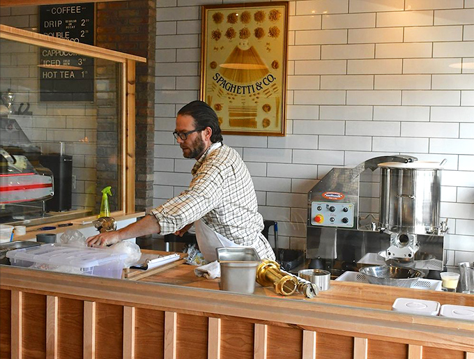 Behind the counter, pasta artisans work their magic, transforming simple ingredients into edible works of art.