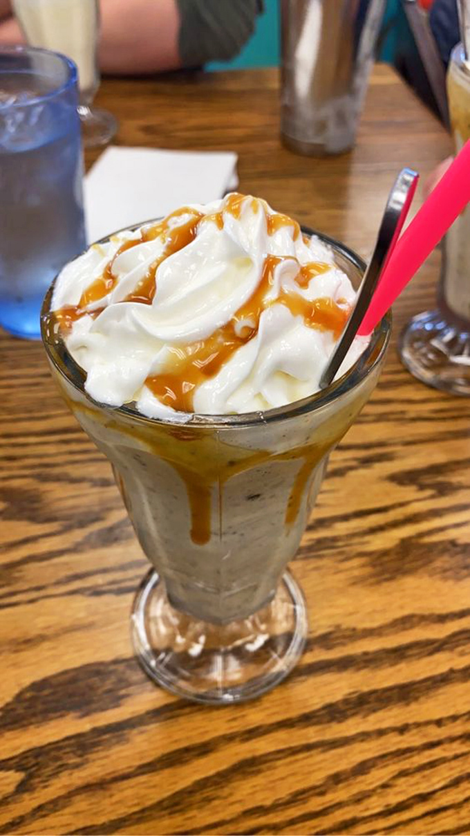 A milkshake topped with enough whipped cream to make your cardiologist wince. That caramel drizzle is pure liquid sunshine.