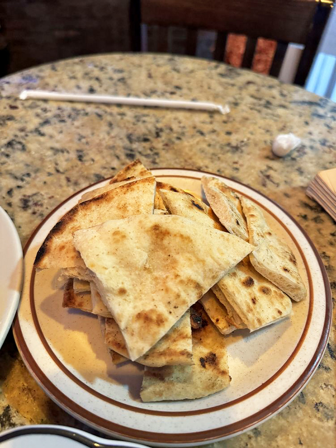 Warm pita triangles, slightly charred and ready for dipping adventures. Bread this good doesn't need to show off &ndash; it knows its worth.