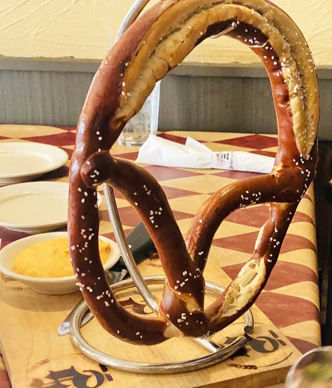 The pretzel hanging majestically on its stand is basically carbohydrate architecture—twisted, salted perfection that demands respect and beer cheese.