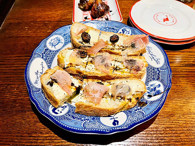 Prosciutto and bread&mdash;the romance that never ends. Thin slices of cured ham draped elegantly over crusty bread with what appears to be a perfect schmear of something creamy.