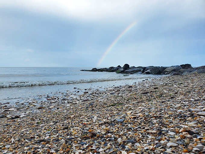 Mother Nature's apology for rain&mdash;a rainbow arches over Matoaka's rocky shore, turning ordinary beach stones into treasure.