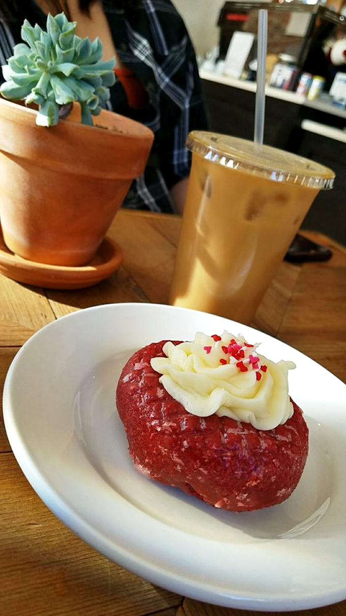 Red velvet donut with cream cheese frosting &ndash; because sometimes your coffee deserves a dance partner that knows all the right moves.