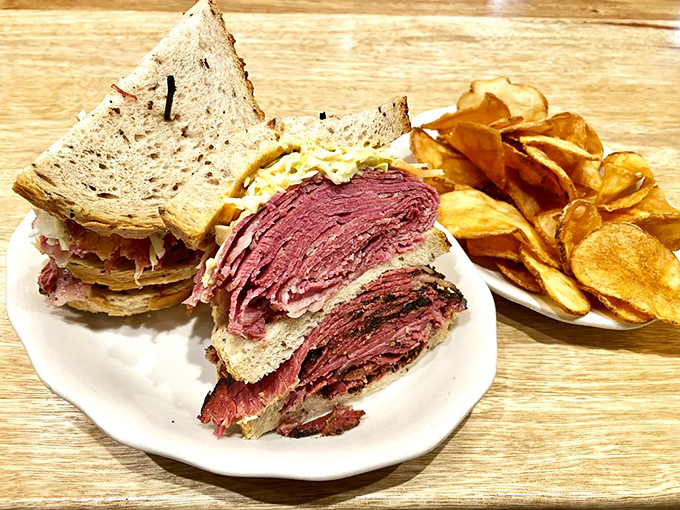 Not just a sandwich but a skyscraper of pastrami and corned beef&mdash;architectural brilliance requiring both hands and possibly a building permit.