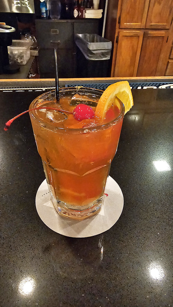 This cocktail isn't just a drink; it's liquid sunshine in a glass. That cherry and orange slice are like a tropical vacation for your taste buds.