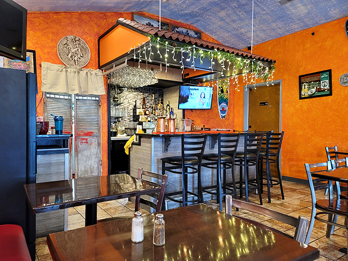 The bar area offers front-row seats to the magic, where tequila transforms into liquid sunshine under twinkling lights.