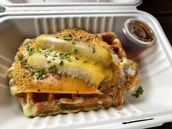 Breakfast alchemy: savory waffle topped with melted cheese and herbs creates gold more valuable than anything in Fort Knox.