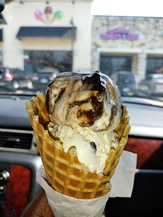 Two cherries stand guard over mountains of whipped cream and ice cream like sweet sentinels of deliciousness.