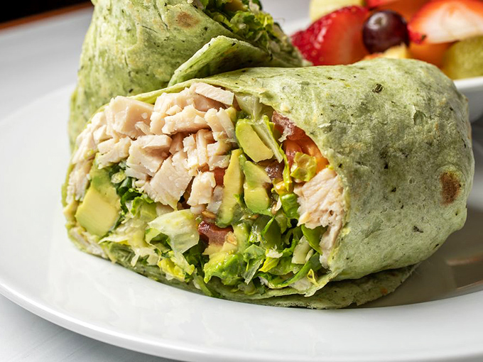 Fresh ingredients wrapped in a vibrant green tortilla&mdash;this isn't just lunch, it's portable happiness with avocado and turkey.