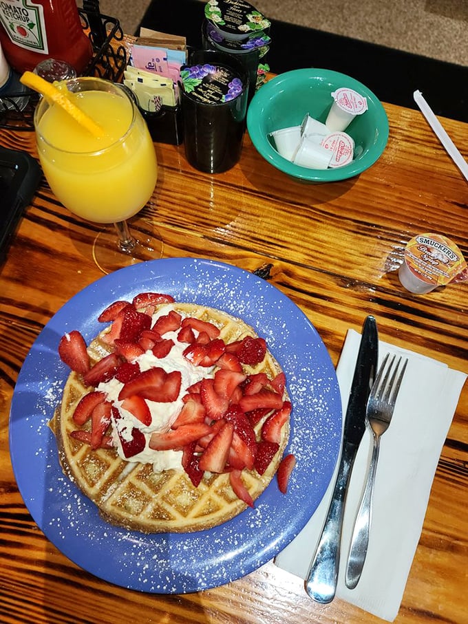 A waffle that's dressed for success with strawberries and cream, alongside orange juice that practically glows with vitamin C.