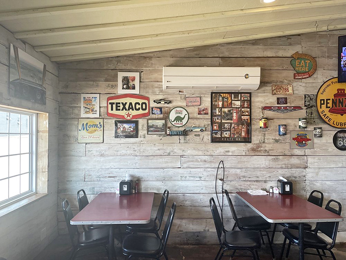 The wooden walls serve as a museum of Americana, where Texaco signs and vintage advertisements tell stories of the open road and simpler times.