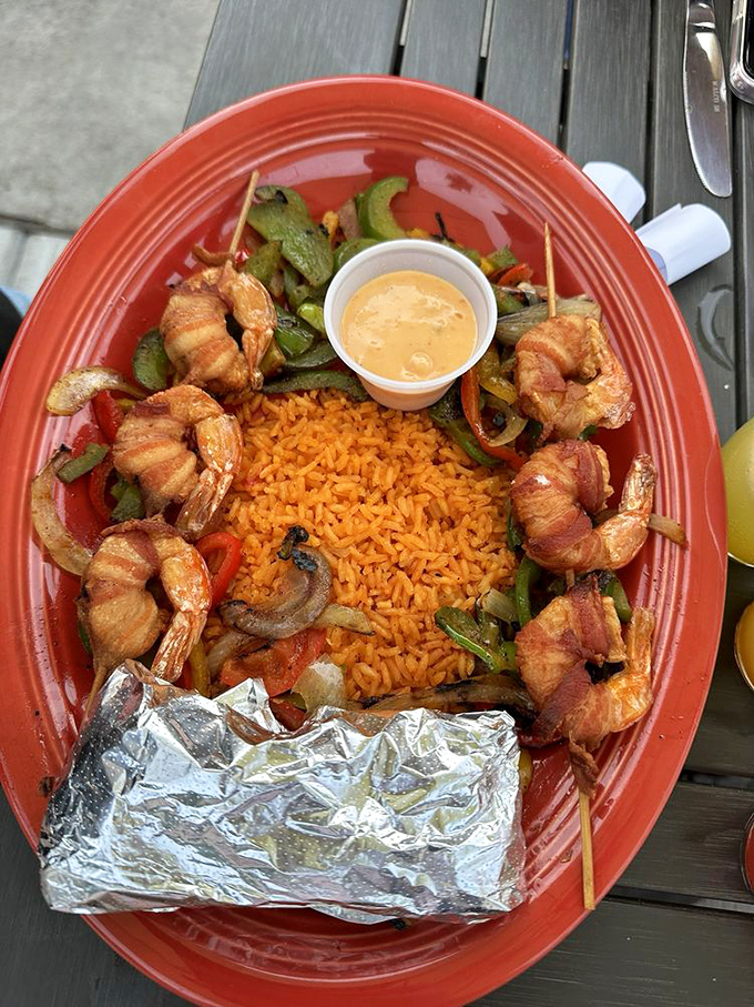 Bacon-wrapped shrimp surrounding a mountain of rice&mdash;because sometimes the best things in life come wrapped in other best things.