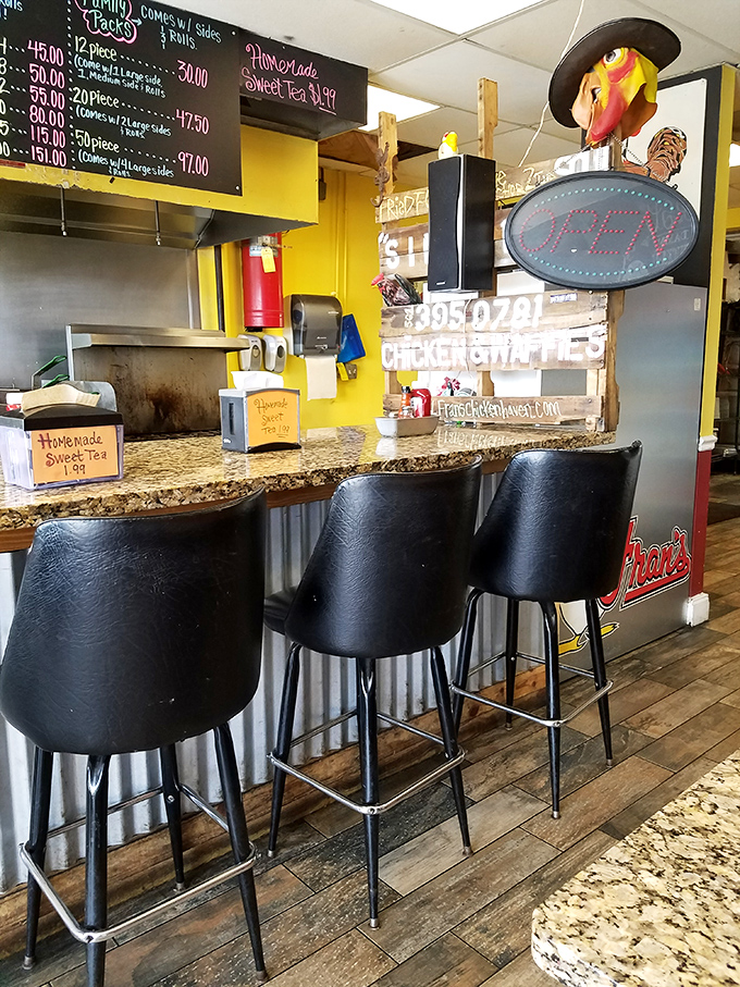 The counter seating offers front-row tickets to the chicken show. That "Open" sign rarely flips to "Closed" before selling out.