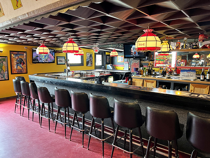 The bar area glows with comic-inspired pendant lights, creating a space where adults can feel like kids while ordering very adult beverages. 