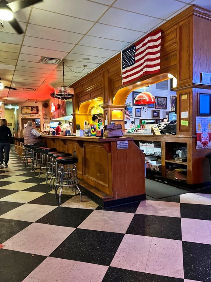 The bar where Oklahoma history meets cold beer. That American flag isn't decoration—it's acknowledging this place is national treasure territory.