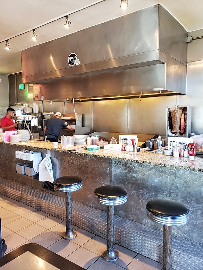 The beating heart of Pete's Kitchen: where short-order magic happens and those chrome stools have supported generations of Denver diners.