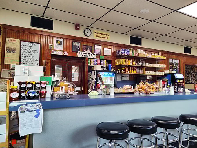 Behind this blue counter, breakfast dreams come true. The shelves stocked with essentials and the pastry case holding treasures worth the trip alone.