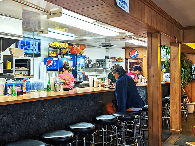 The counter where magic happens&mdash;where orders are called out in a language perfected over years, and where solo diners find community in shared appreciation of simplicity.