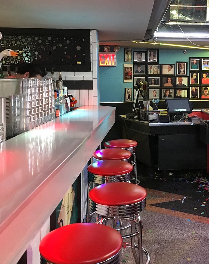 The counter seating offers a backstage pass to the action, where classic diner charm meets theatrical flair under the glow of neon lights.