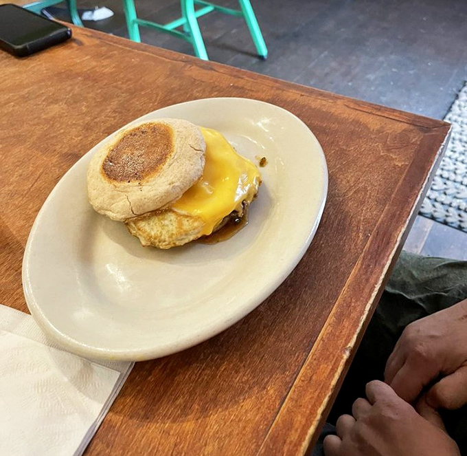 The humble breakfast sandwich, elevated to art form. That melted cheese is making a break for freedom, and who could blame it?