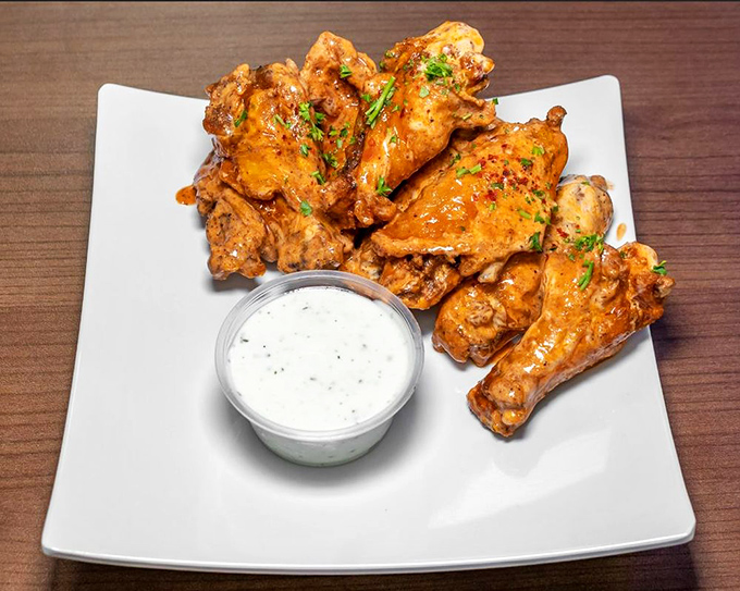 These aren't just wings; they're flavor ambassadors with diplomatic immunity from blandness. The cooling dip stands by, ready for emergency heat relief.
