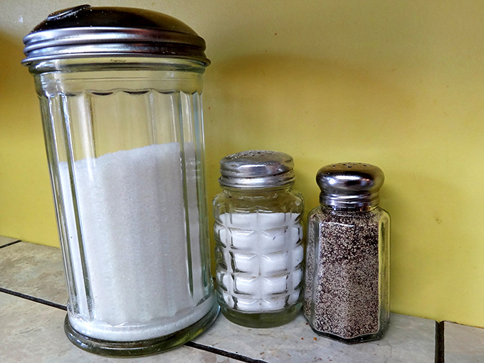 The essentials: sugar, salt, and pepper&mdash;the holy trinity of diner seasonings standing at attention, ready to enhance your breakfast experience.