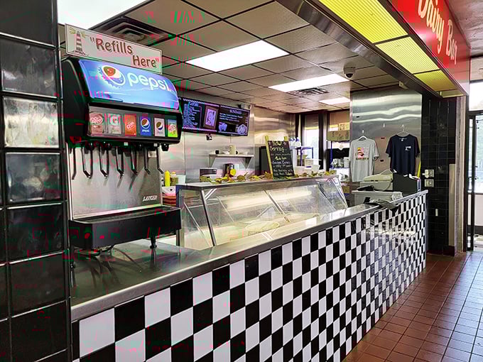 The black-and-white checkered counter isn't just retro—it's where magic happens, where sodas are dispensed and orders fly faster than gossip.