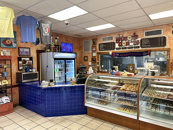 Behind the counter, where donut magic happens, cases display the day's treasures while Memphis sports pride decorates every available wall space.