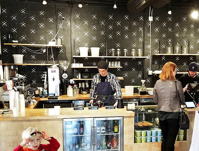 Behind this counter, baristas perform coffee magic with the focused precision of symphony conductors and the friendly approachability of neighborhood bartenders.