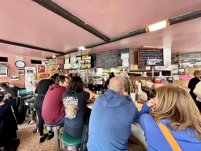 Where strangers become neighbors at the counter. The pink walls have heard decades of stories, confessions, and breakfast orders shouted with confidence.