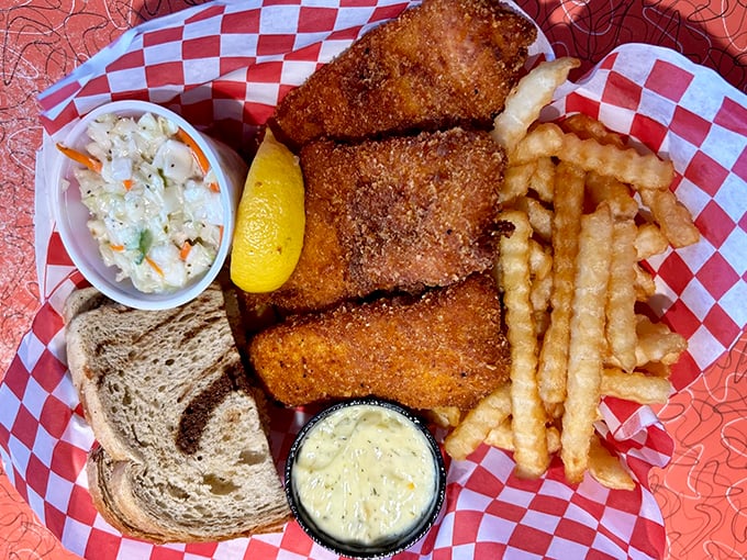 The fish fry basket: where crispy golden fillets meet crinkle-cut fries and coleslaw in Wisconsin's unofficial state dinner, perfected at Wayne's.