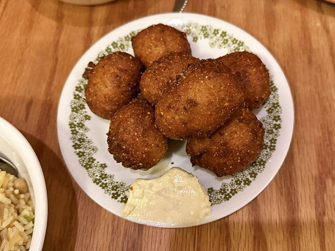 Hush puppies so perfectly golden they belong in Fort Knox. Crispy exterior giving way to pillowy interior&mdash;the textural equivalent of a standing ovation.
