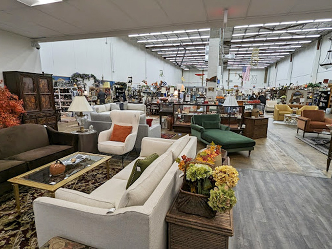 A showroom so vast it needs its own ZIP code, where white sofas and emerald accent chairs create conversation pods for imaginary parties.