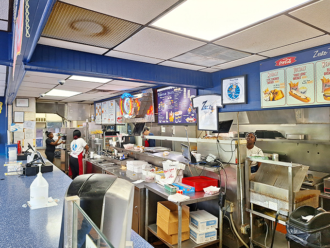 Behind the scenes where fast food magic happens. The bustling kitchen reveals the organized chaos that delivers your burger with remarkable efficiency.