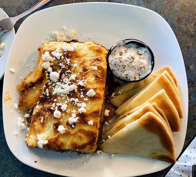 Moussaka isn't just comfort food&mdash;it's what happens when eggplant, potatoes, and seasoned beef throw a party under a b&eacute;chamel blanket.