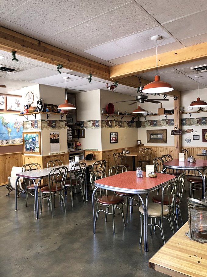 The dining room has that perfect lived-in feeling, where orange-topped tables and wooden accents create a morning sanctuary that feels like coming home.