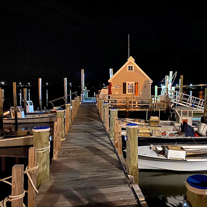 The marina at night transforms into a magical scene where boats rest after a day's work and the little dock house glows like a lighthouse for hungry sailors.