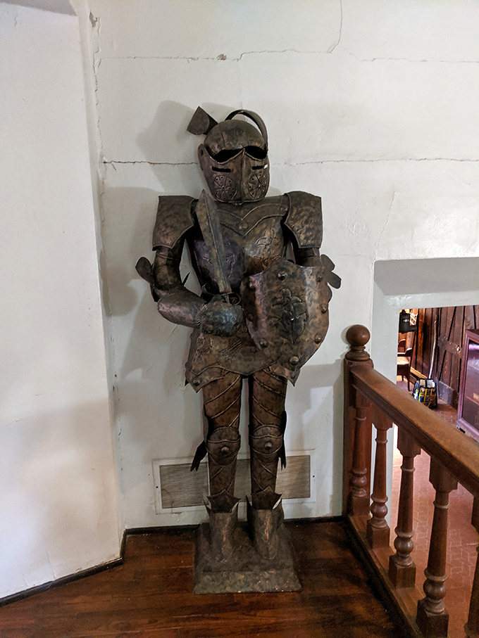 This silent sentinel guards the stairway with metallic dignity. He hasn't moved in centuries, which is either dedication or really good job security.