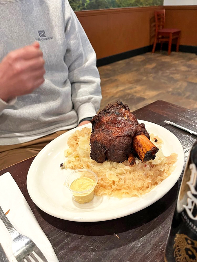 This isn't just meat&mdash;it's a monument to slow-cooking. Perched atop a bed of sauerkraut, this pork shank looks ready to star in its own food documentary.