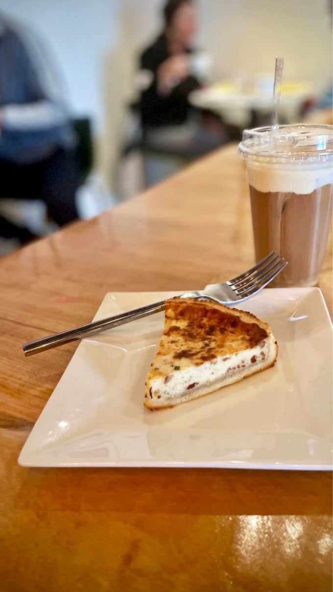 Quiche and coffee: the power lunch of creative thinkers. This slice isn't just breakfast&mdash;it's fuel for your next brilliant idea.